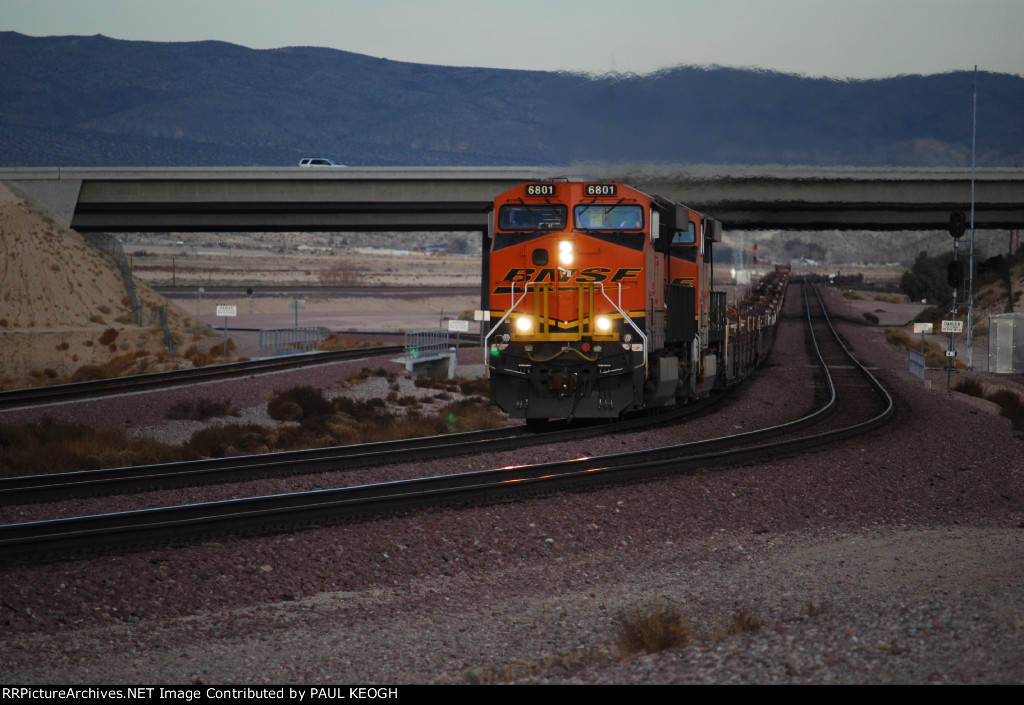 BNSF 6801 heads west as she gets closer to me leading a Bare Table Train.